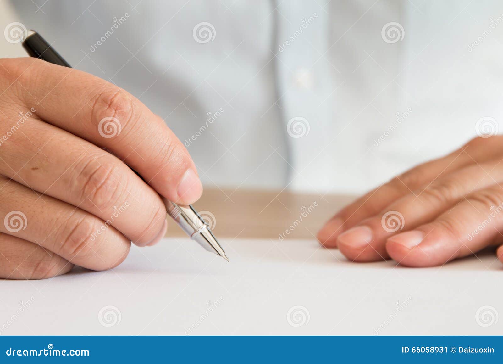 Signing Of Documents For Permits, Consent. Hands Hold A Pen Over Paper ...