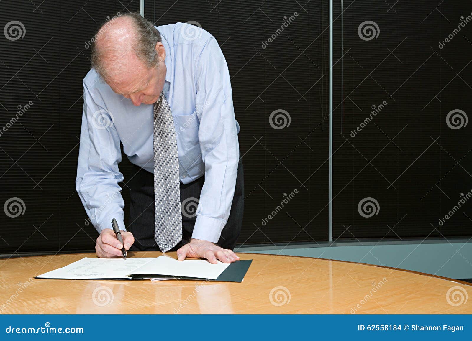 Businessman Signing Paperwork Stock Photo - Image of aging, male: 62558184