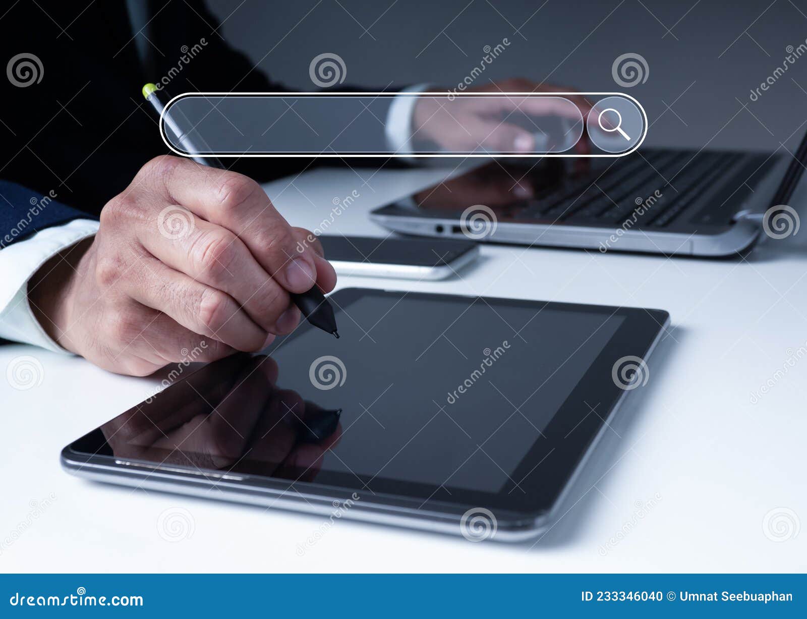 A Businessman Sits at a Desk, Working on a Laptop Computer. with a ...