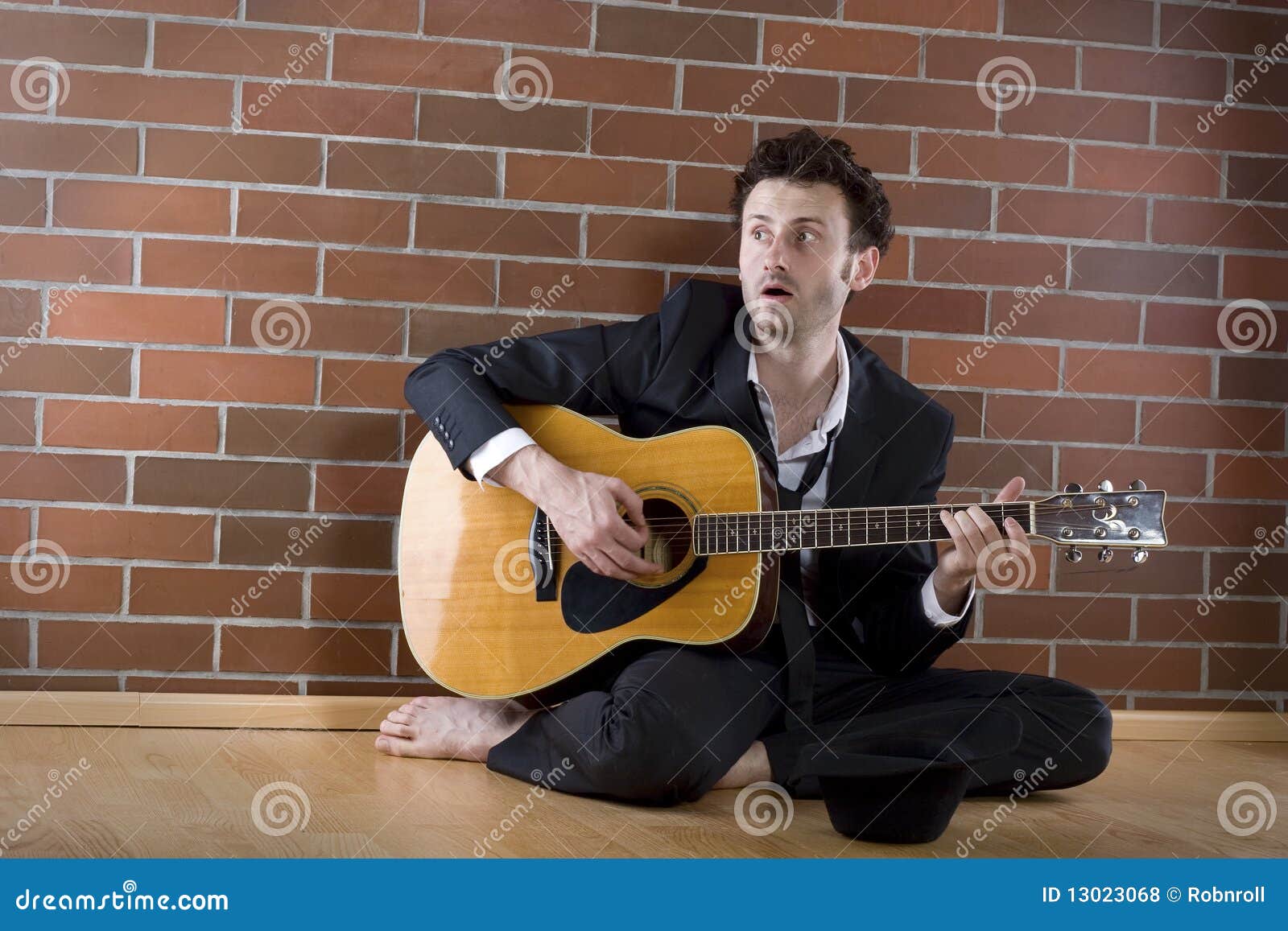 Businessman Sits Singing with Guitar on the Floor Stock Photo - Image ...