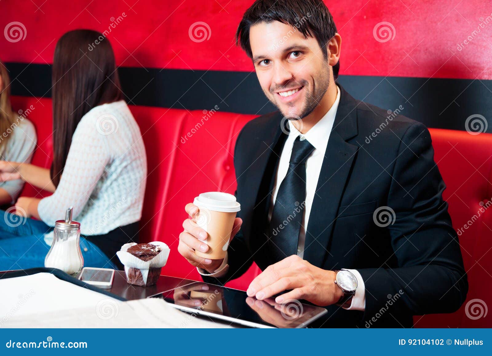 Businessman Sitting in a Cafe, Working on His Tablet Stock Photo ... Businessman Sitting in a Cafe, Working on His Tablet Stock Photo ...
