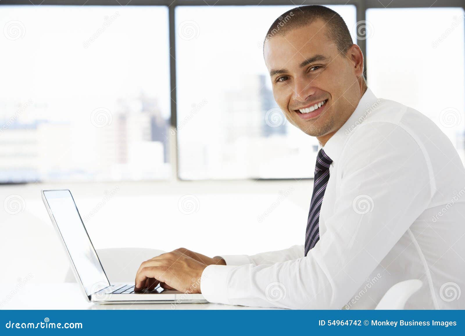 Businessman Sitting at Desk in Office Using Laptop Stock Photo - Image ... Businessman Sitting at Desk in Office Using Laptop Stock Photo - Image ...