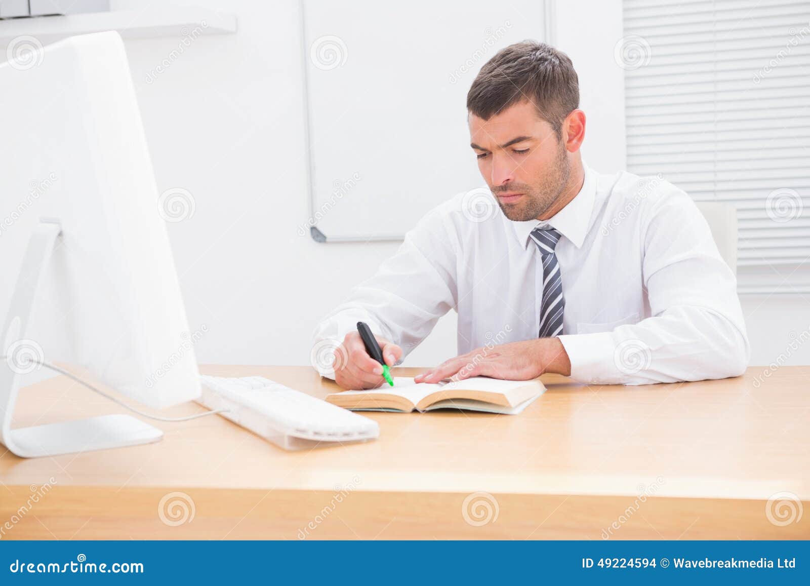Businessman Sitting at Desk Reading a Book Stock Photo - Image of ...