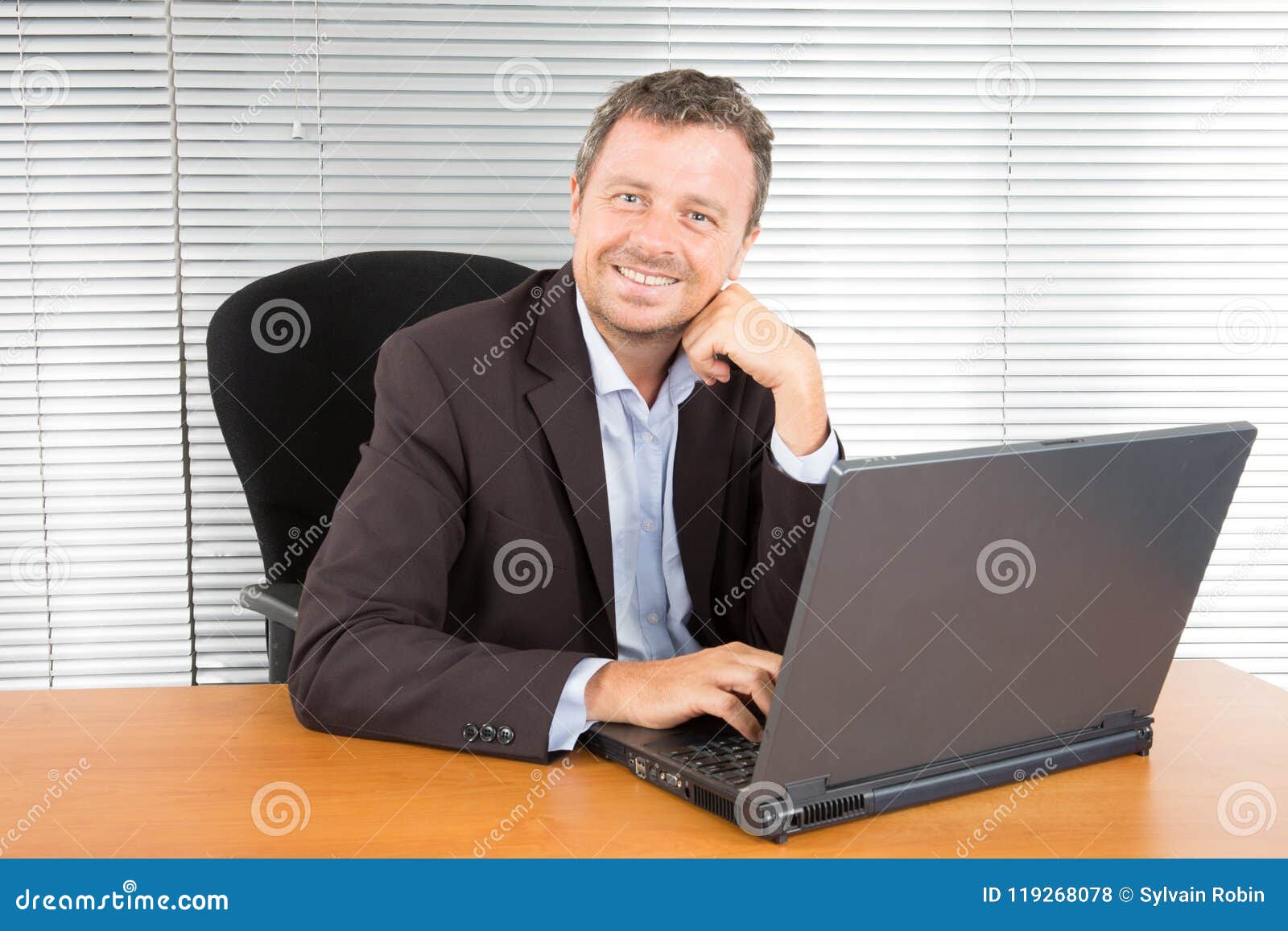 Businessman Sitting in Front of Laptop Stock Photo - Image of person ...