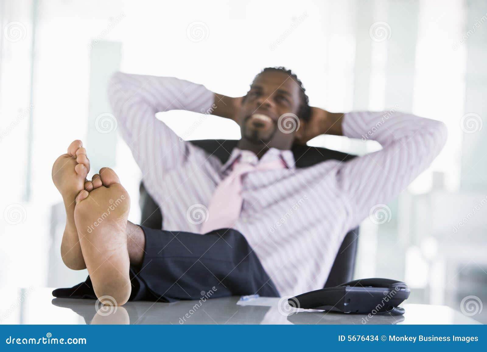 Businessman Sitting in Office with Feet on Desk Stock Photo - Image of ...