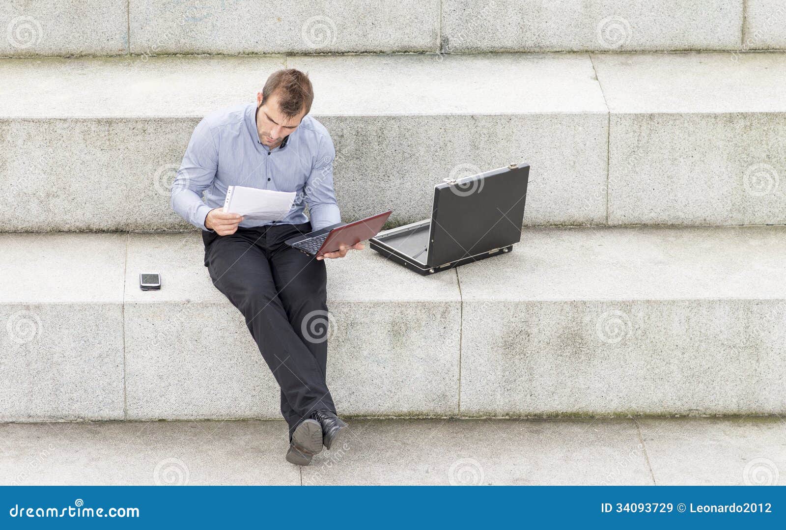 Businessman Sitting on the Steps and Working with Computer. Stock Image ...