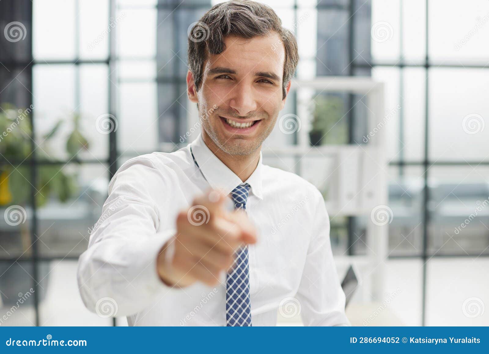 Businessman Sitting on the Table and Pointing at You Stock Photo ...