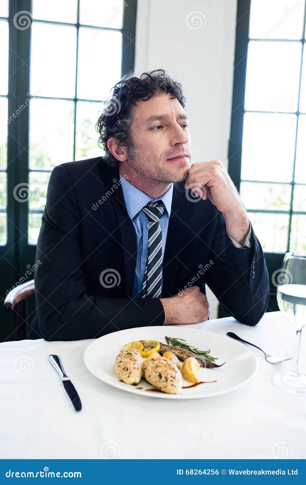 Businessman Sitting at Table Stock Photo - Image of mature, dressed ...