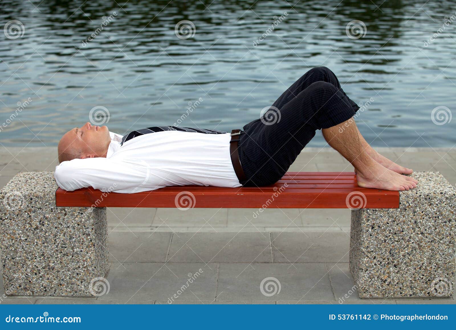 Businessman Sleeping on Bench with Hands Behind Head Stock Photo ...