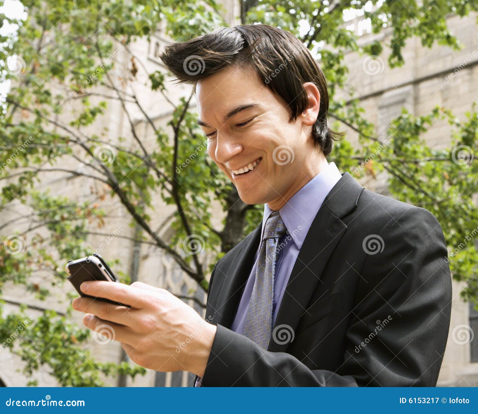Businessman Smiling at Cell Phone Message. Stock Image - Image of ...