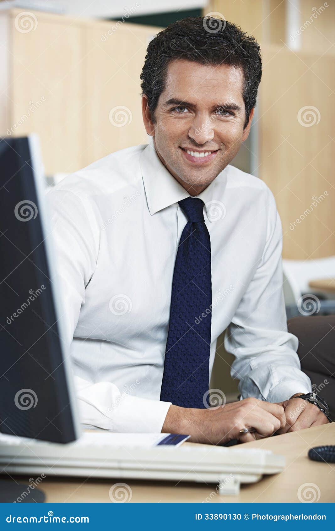 Businessman Smiling at Computer Desk Stock Photo - Image of looking ...