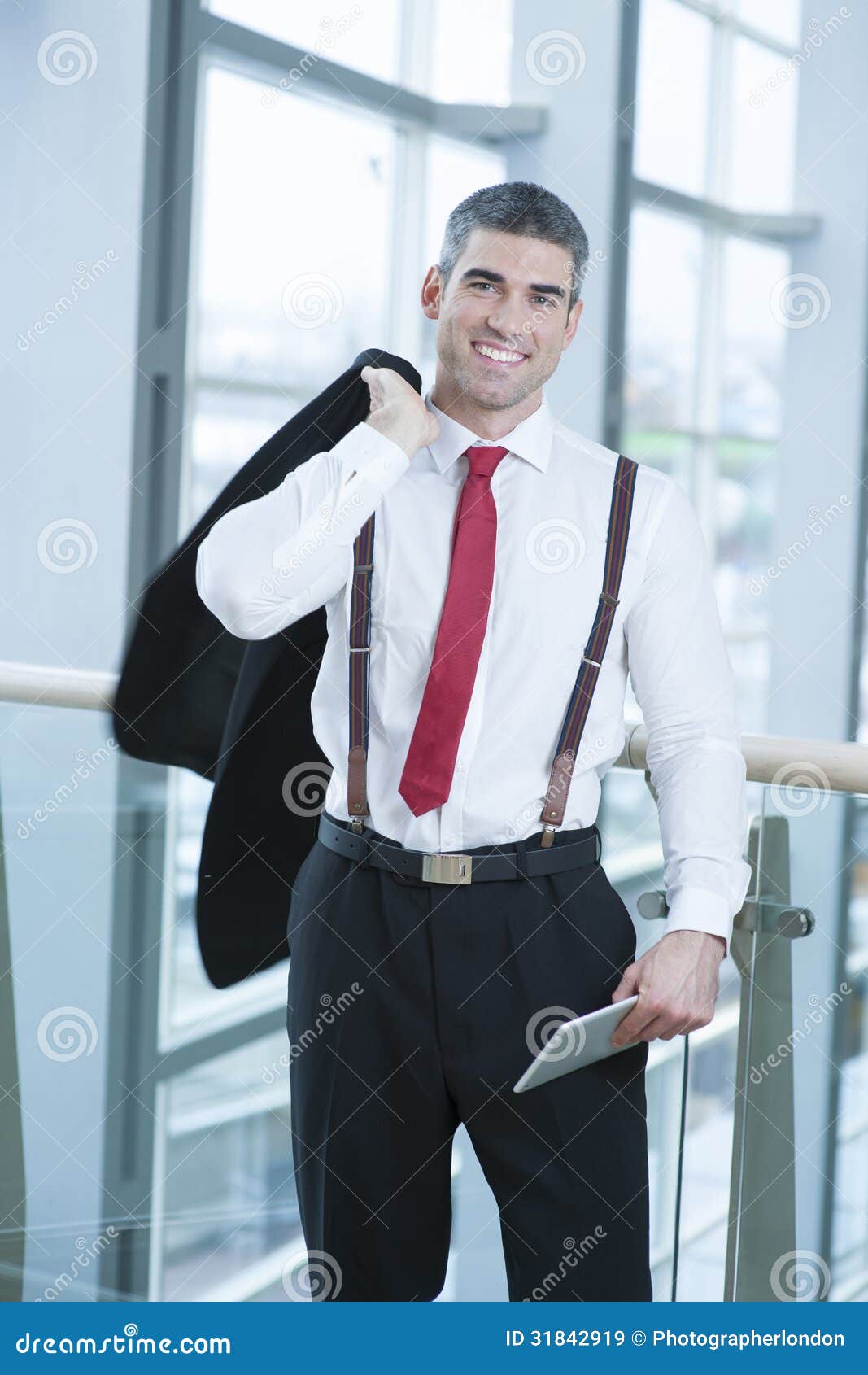 Businessman Smiling and Looking at Camera with Jacket Over Shoulder ...