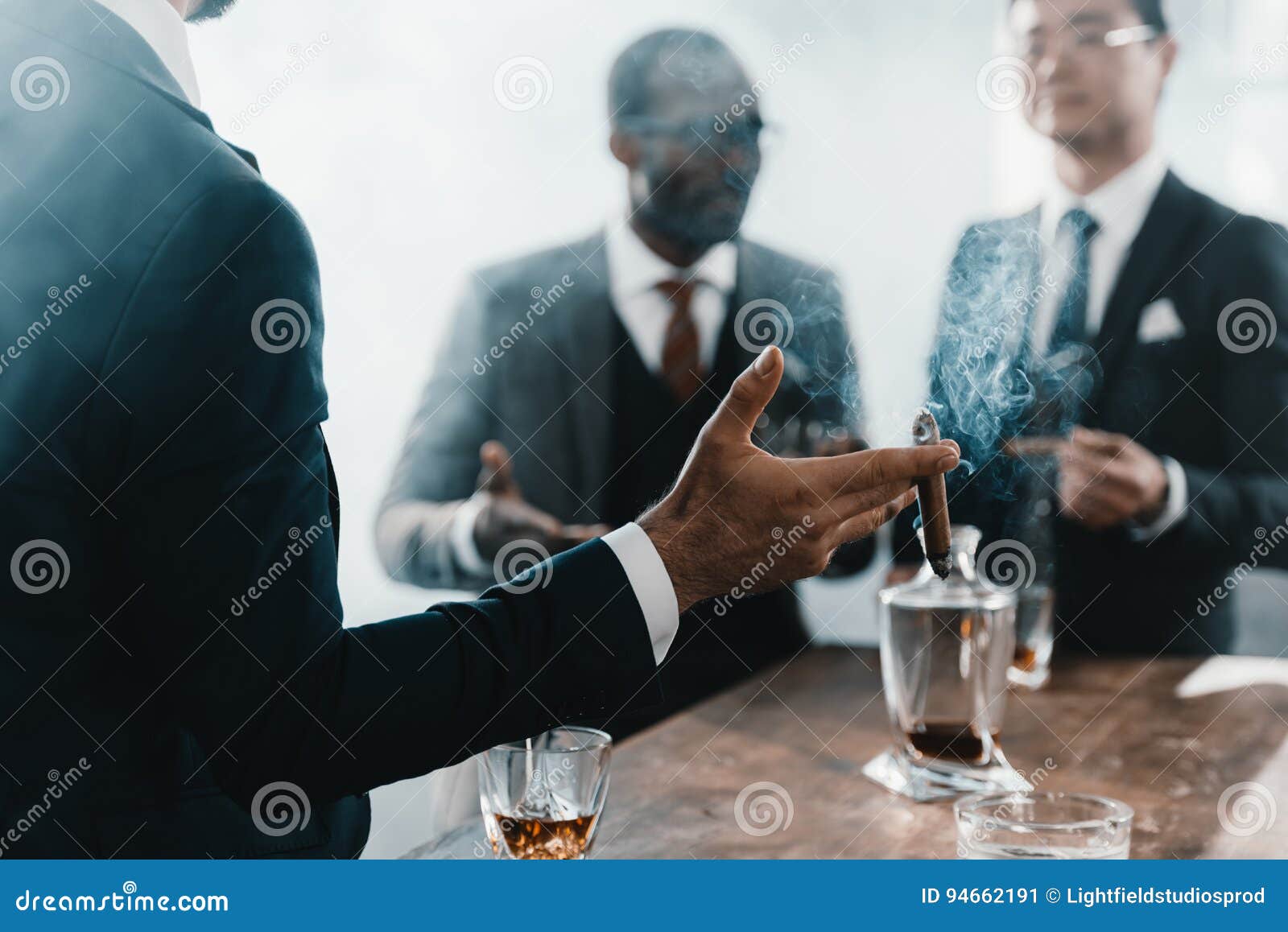 Businessman Smoking Cigar with Multicultural Business Team Stock Image ...