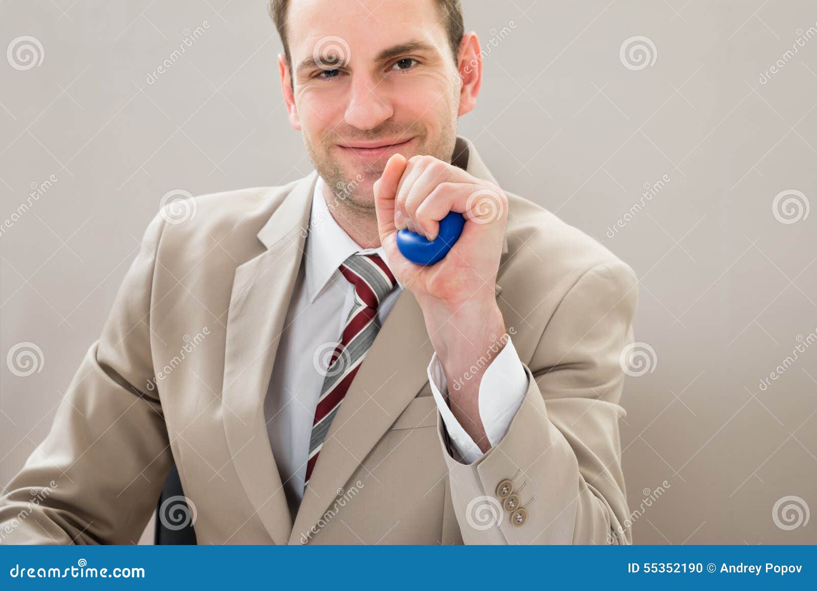 Businessman Squeezing Blue Stressball Stock Photo - Image of formalwear ...