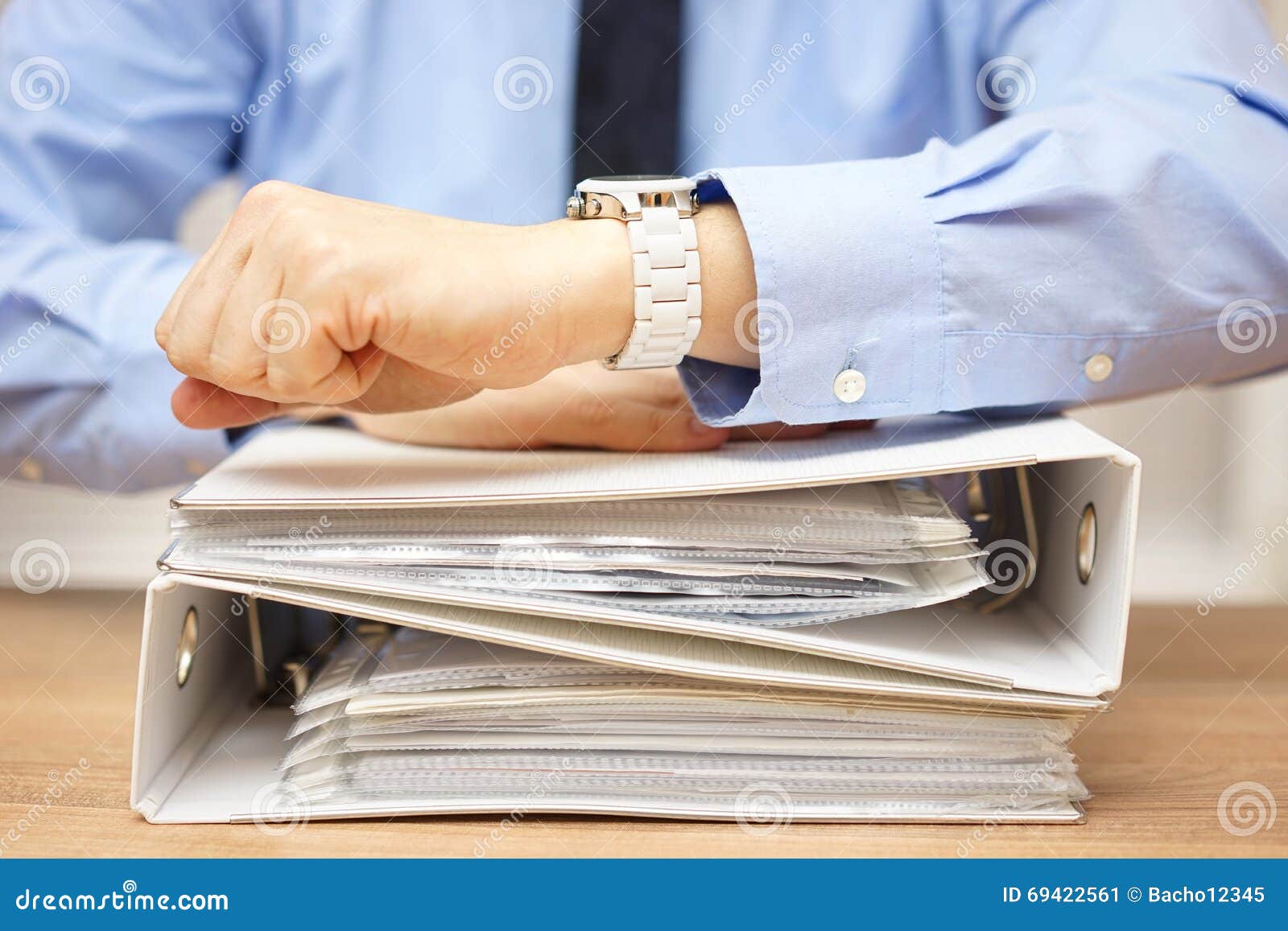 Businessman with Stack of Documentation on the Desk Looking on W Stock ...