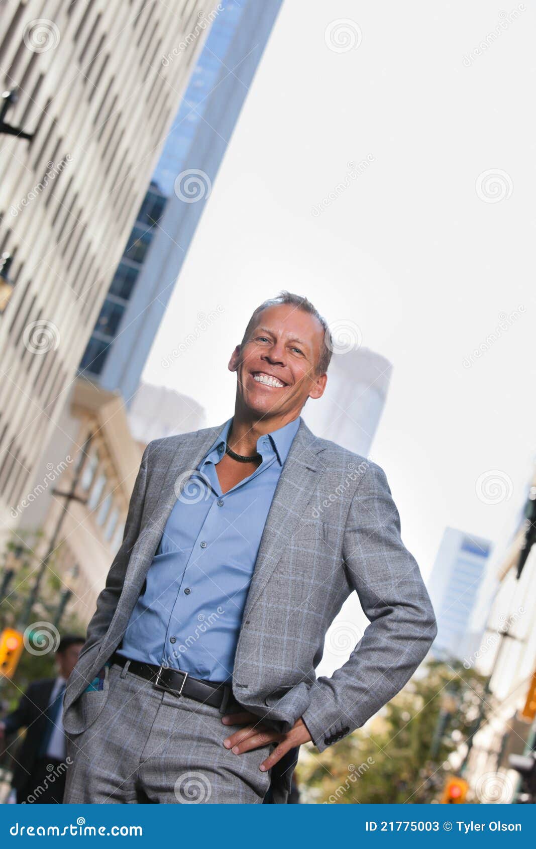 Businessman Standing with Buildings in Background Stock Image - Image ...