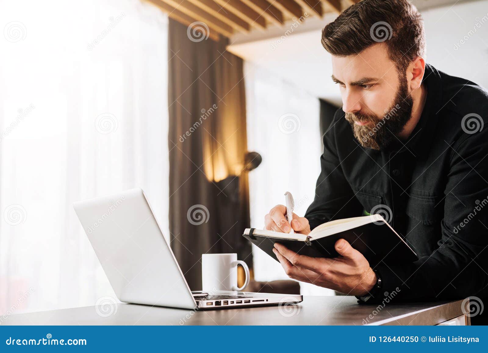 Businessman Is Standing By Computer Looking At Laptop Screen Making