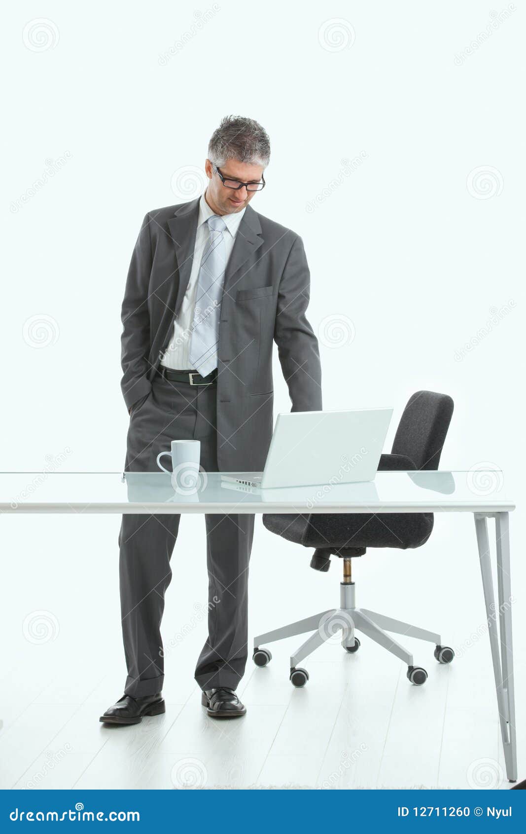 Businessman Standing at Desk Stock Photo - Image of face, laptop: 12711260