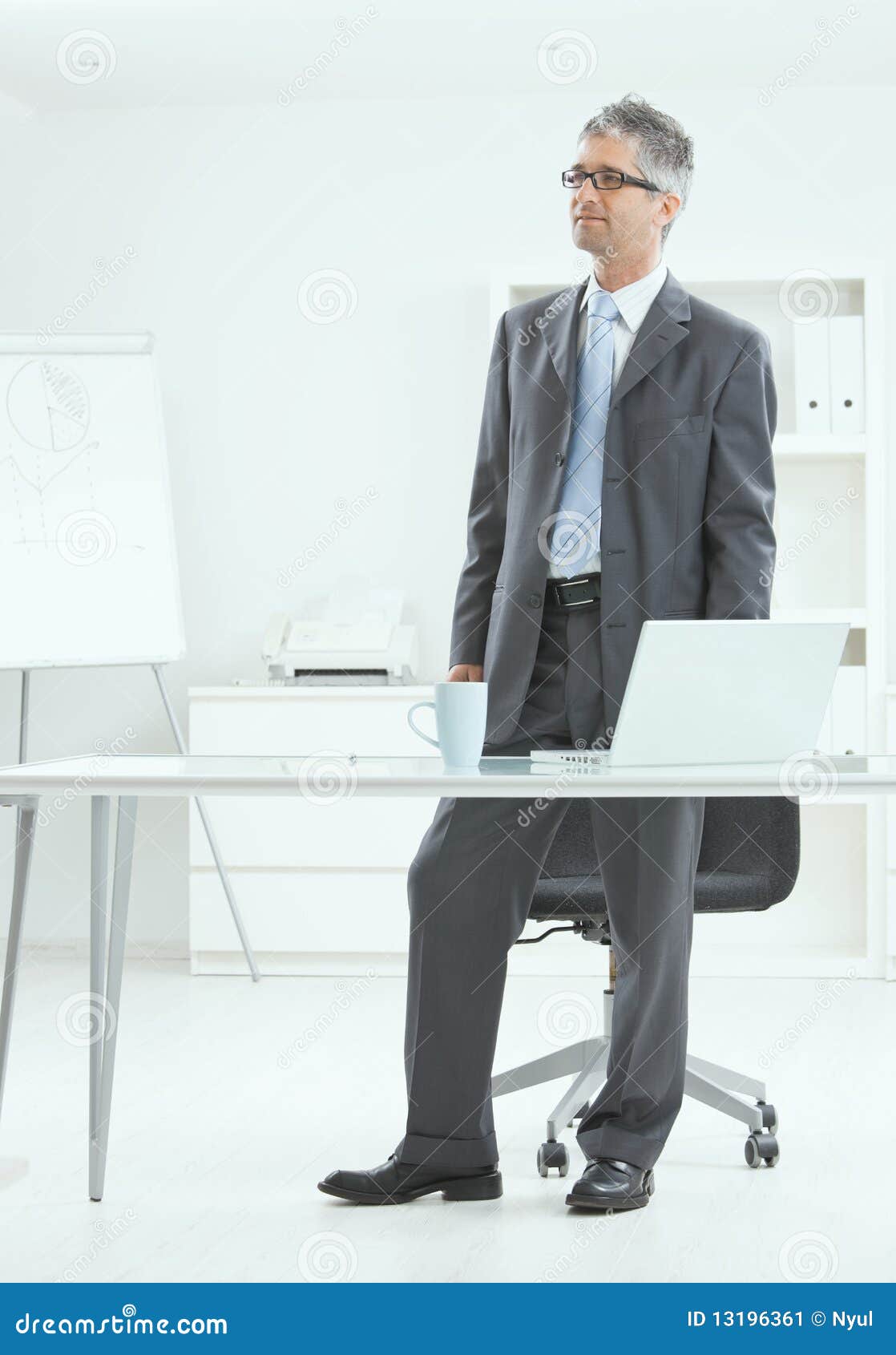 Businessman Standing at Desk Stock Image - Image of laptop ...