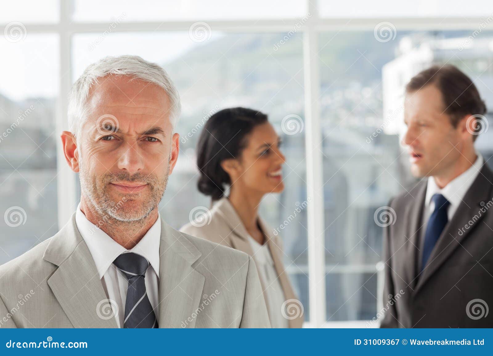 Businessman Standing in Front of Colleagues Speaking Together Stock ...