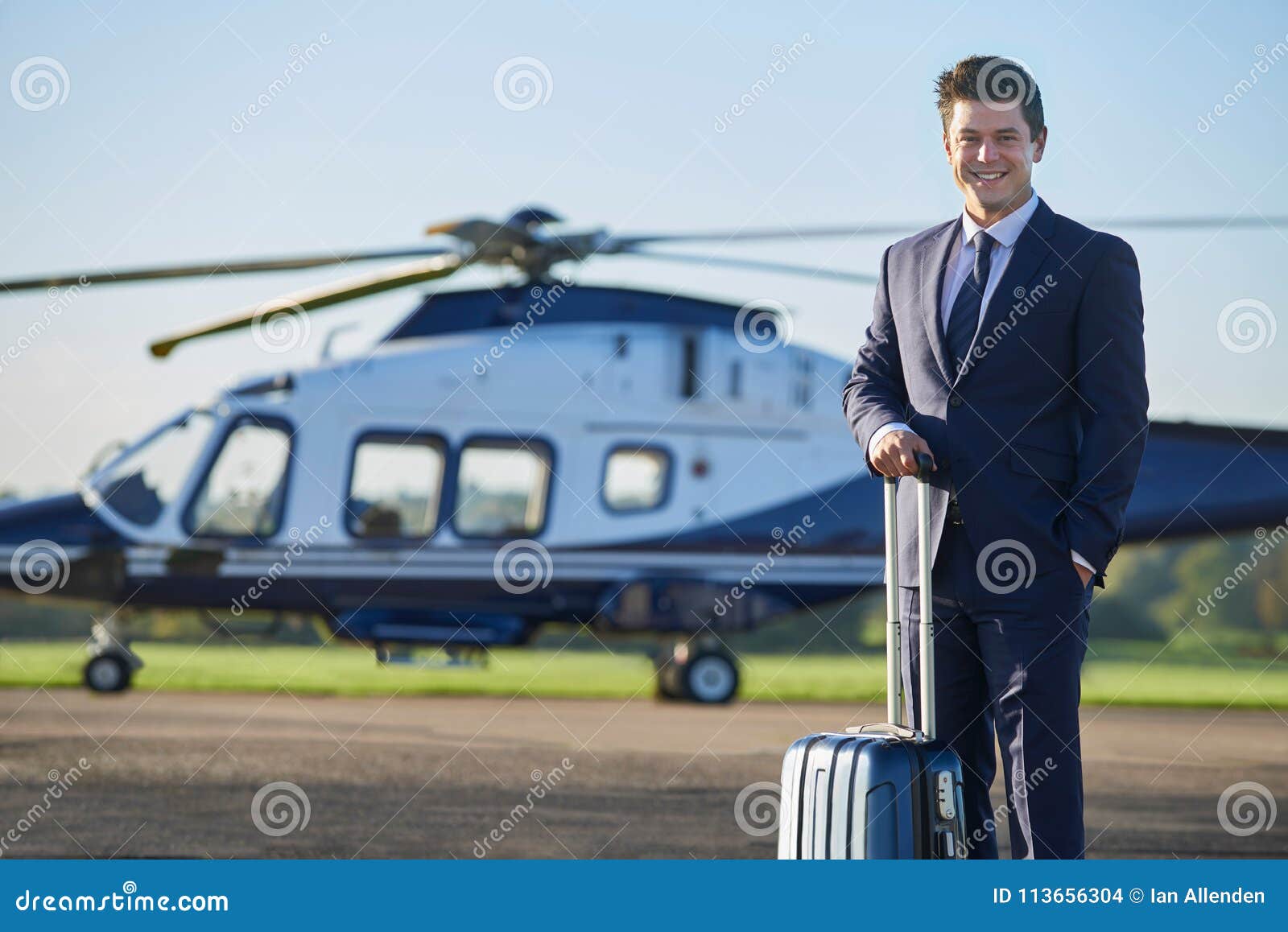 Portrait of Businessman Standing in Front of Helicopter Stock Photo ...