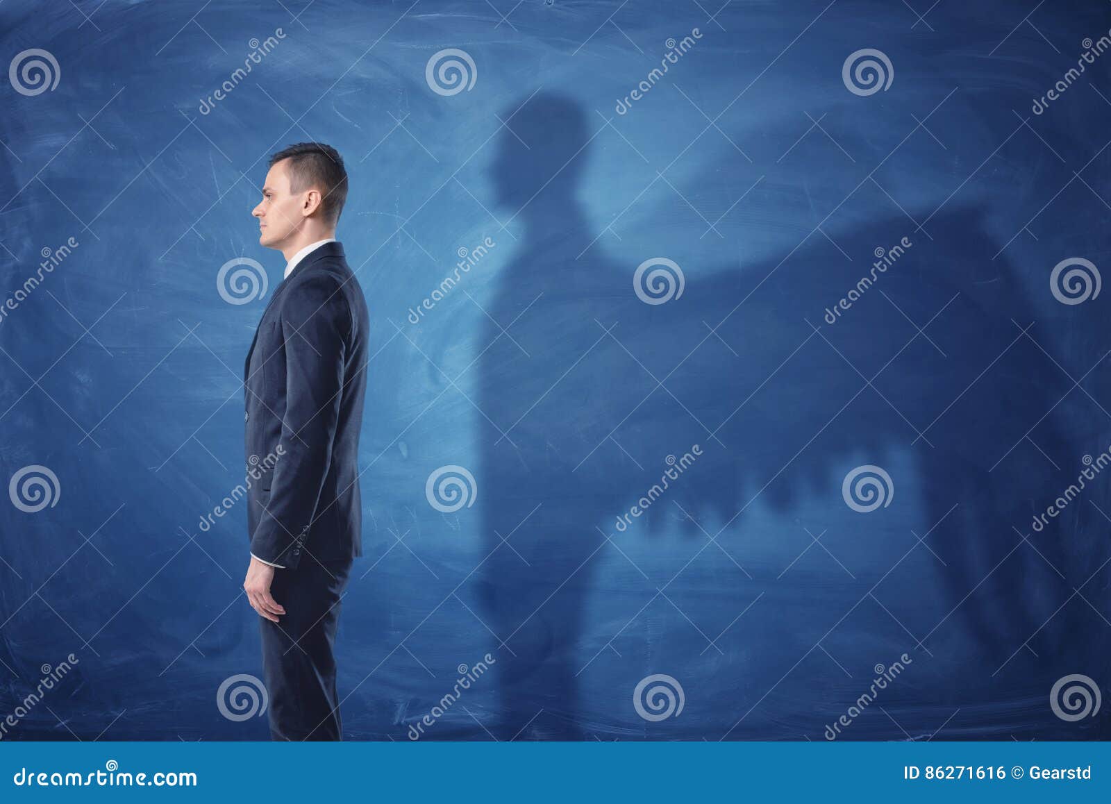 Businessman is Standing in Profile and Casting a Shadow of Angel Wings ... Businessman is Standing in Profile and Casting a Shadow of Angel Wings ...