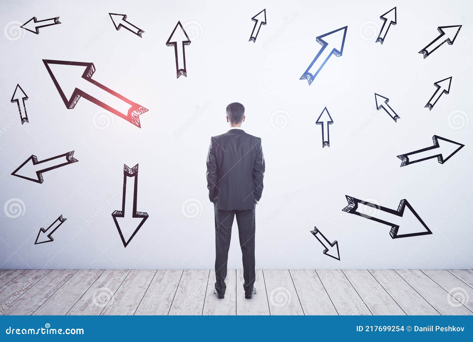 Businessman Standing Puzzled In Front Of A Wall With Multiple Black
