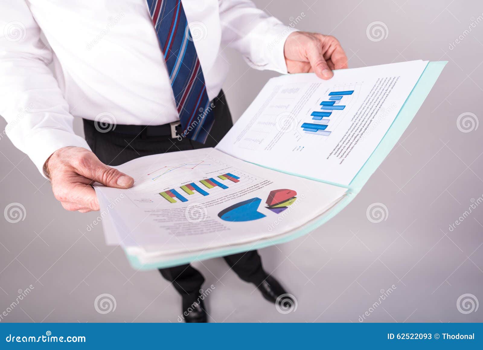 Businessman Standing, Reading a Report Stock Image - Image of graph ...