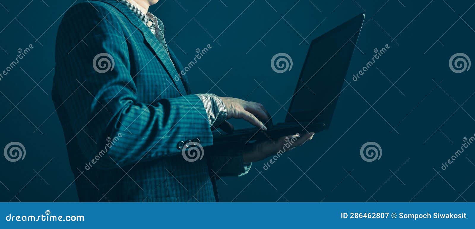 Businessman Standing Sideways Holding and Typing Laptop Computer Stock ...