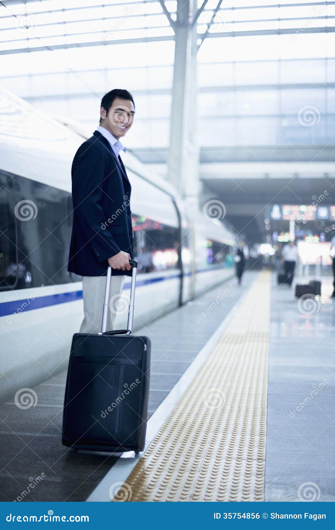 Businessman Standing with a Suitcase on the Railroad Platform by a High ...