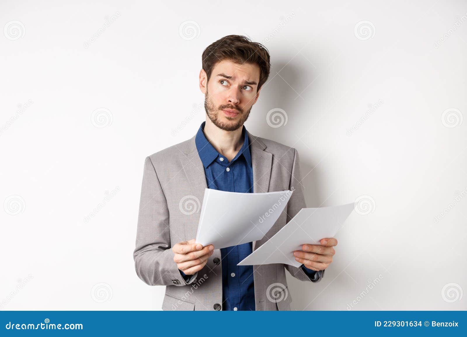 Businessman in Suit Looking through Papers, Reading Documents at Work ...
