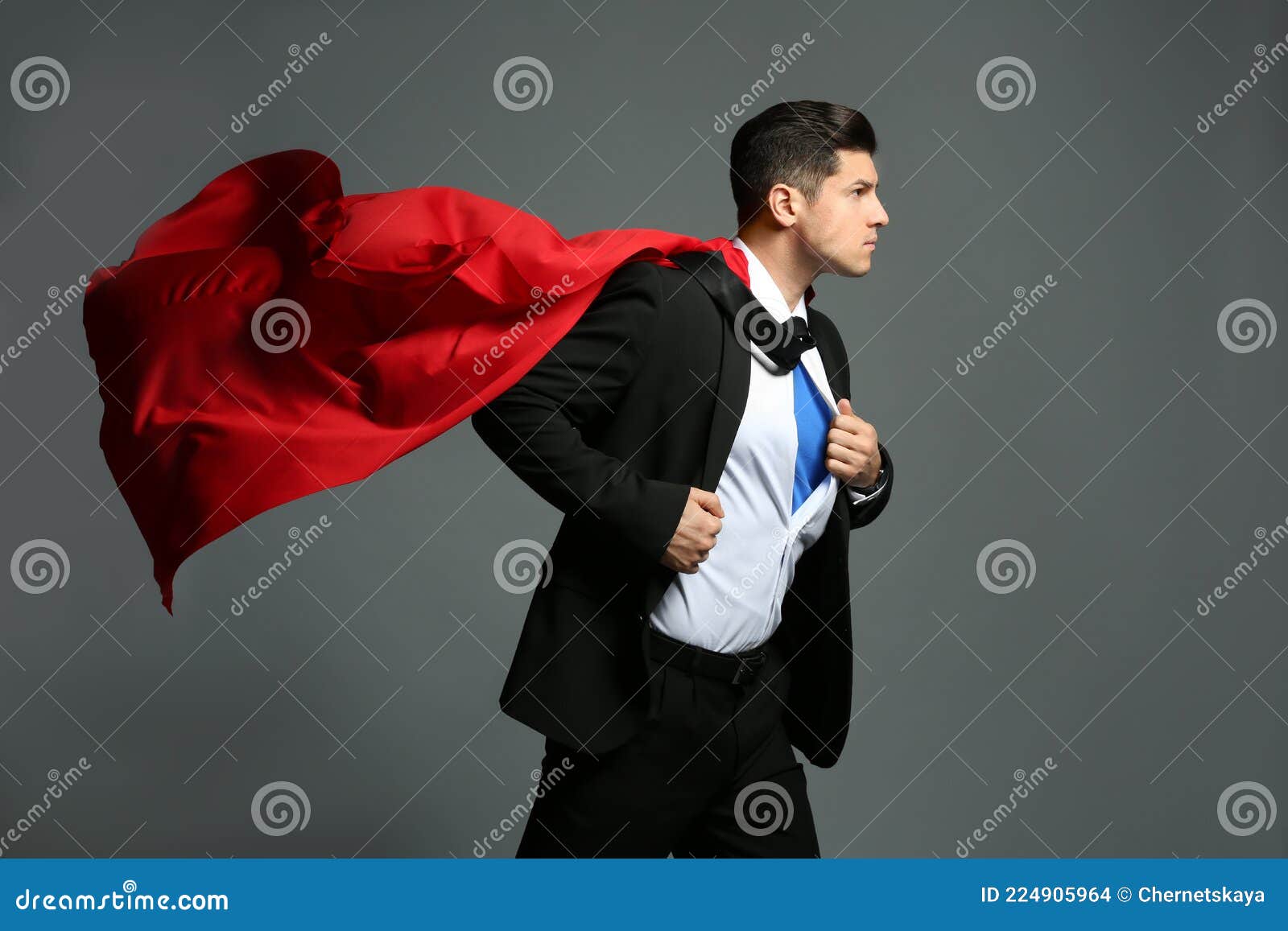 Businessman in Superhero Cape Taking Suit Off on Grey Stock Photo ...