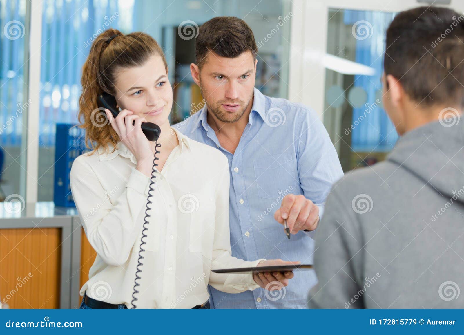 Businessman Supervising Trainee Receptionist on Telephone Stock Image ...