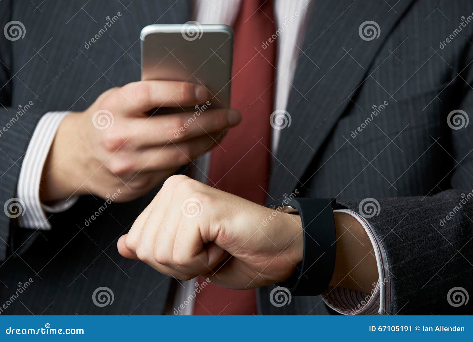 Businessman Synchronizing Smart Watch with Mobile Phone Stock Image ...