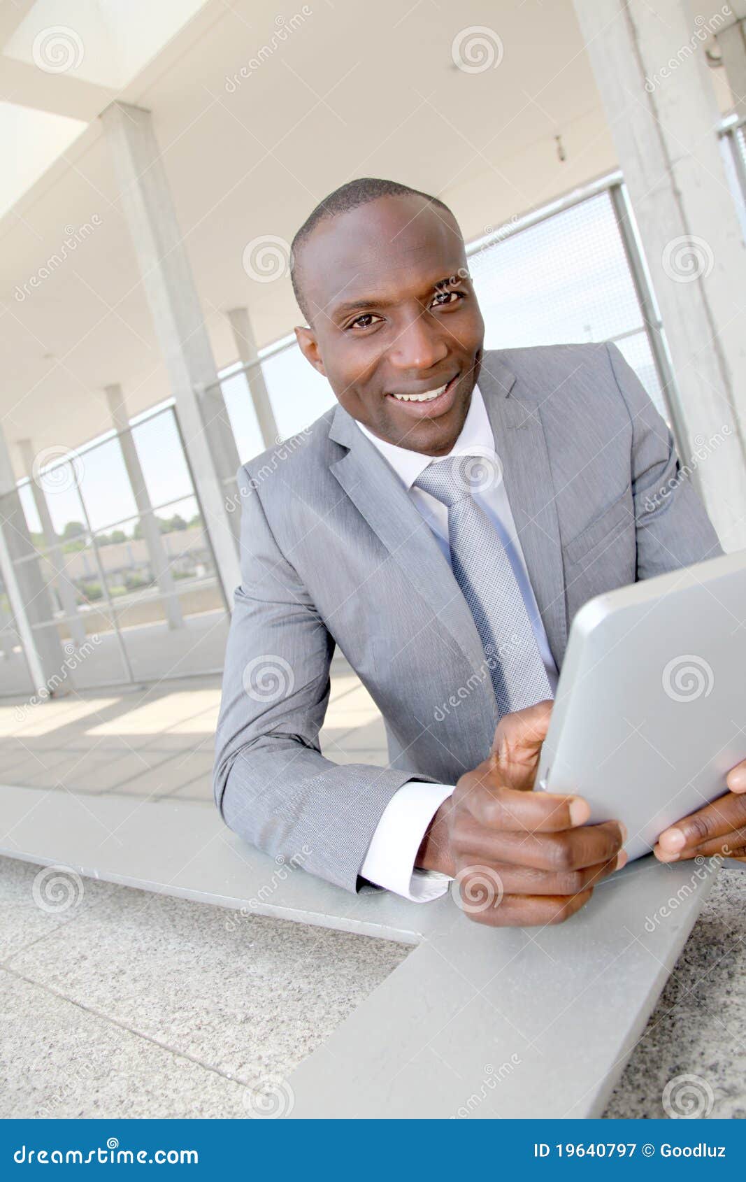 Businessman with tablet stock image. Image of american - 19640797