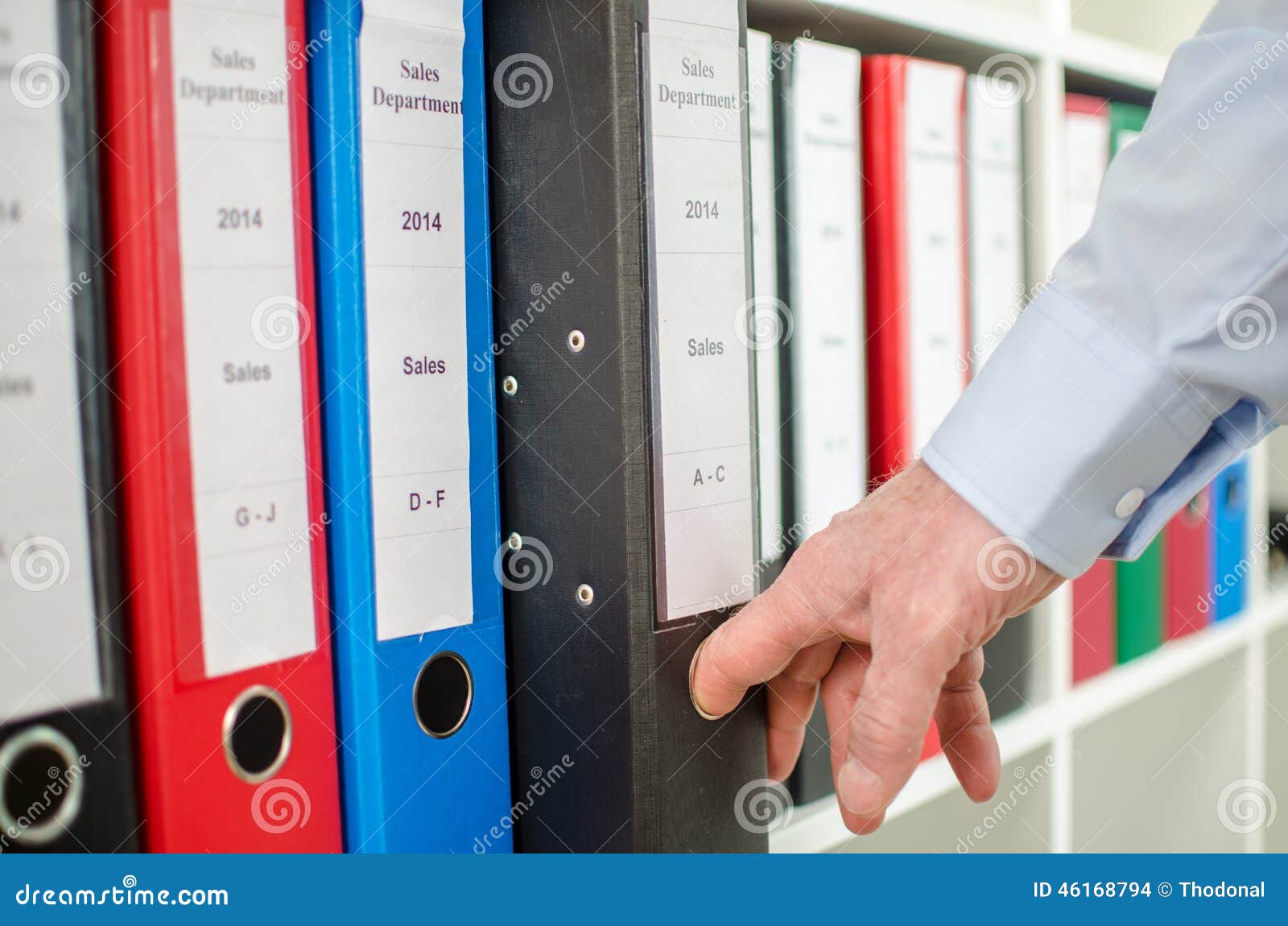 Businessman Taking Out a Binder from the Shelf Stock Photo - Image of ...
