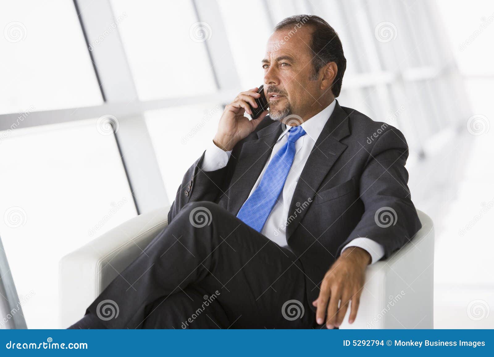 Businessman Talking on Mobile Phone in Lobby Stock Photo - Image of ... Businessman Talking on Mobile Phone in Lobby Stock Photo - Image of ...