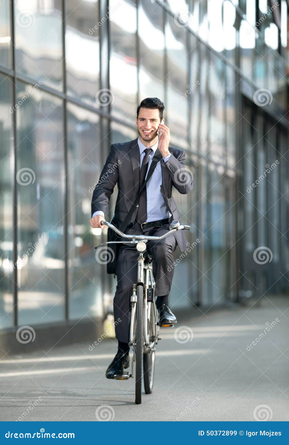Businessman Talking with Mobile Phone and Riding a Bicycle Stock Image ...