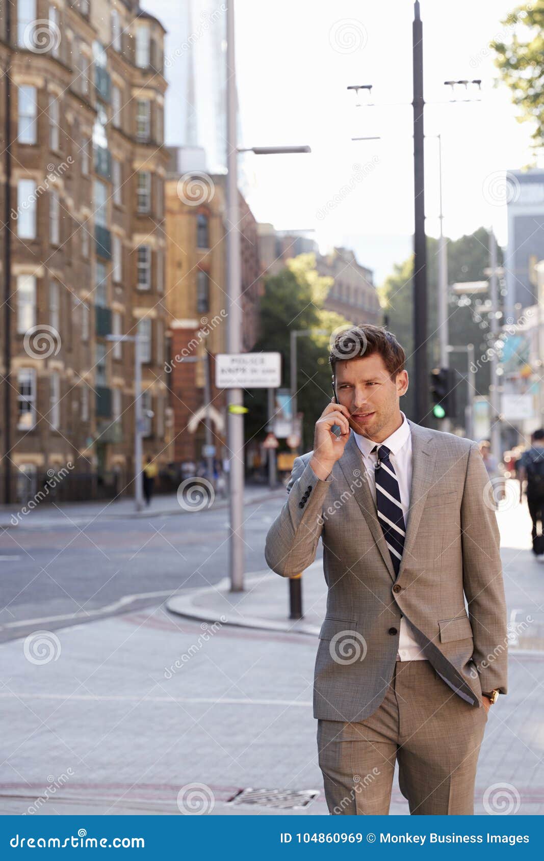 Businessman Talking on Mobile Phone Walking Along City Street Stock ... Businessman Talking on Mobile Phone Walking Along City Street Stock ...