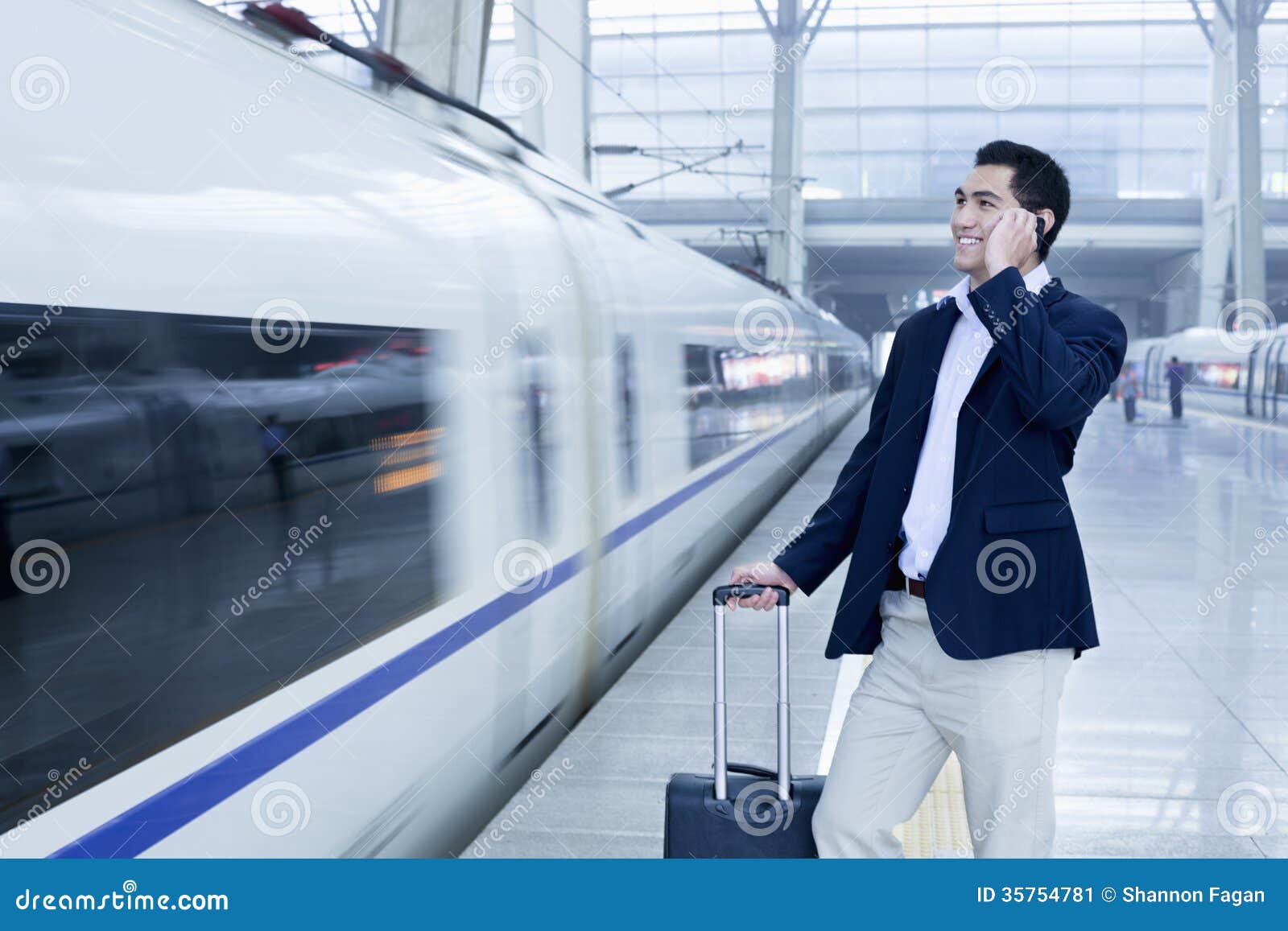 Businessman Talking on the Phone on the Railroad Platform by a High ...