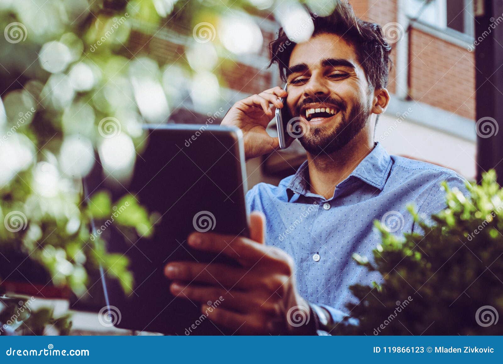 Businessman Talking on Smart Phone and Using Digital Tablet. Stock ...