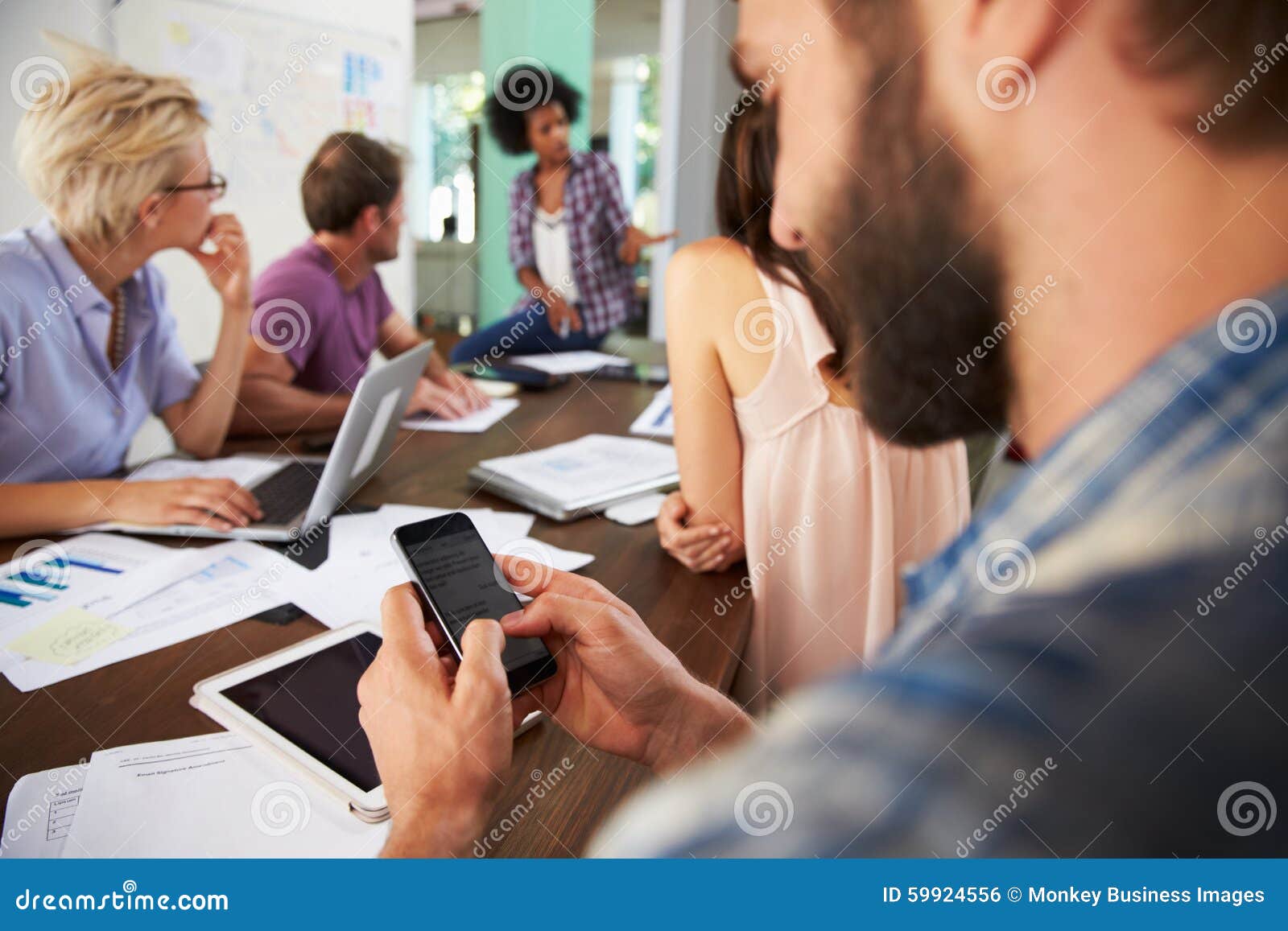 Businessman Texting during Meeting in Office Stock Photo - Image of ...