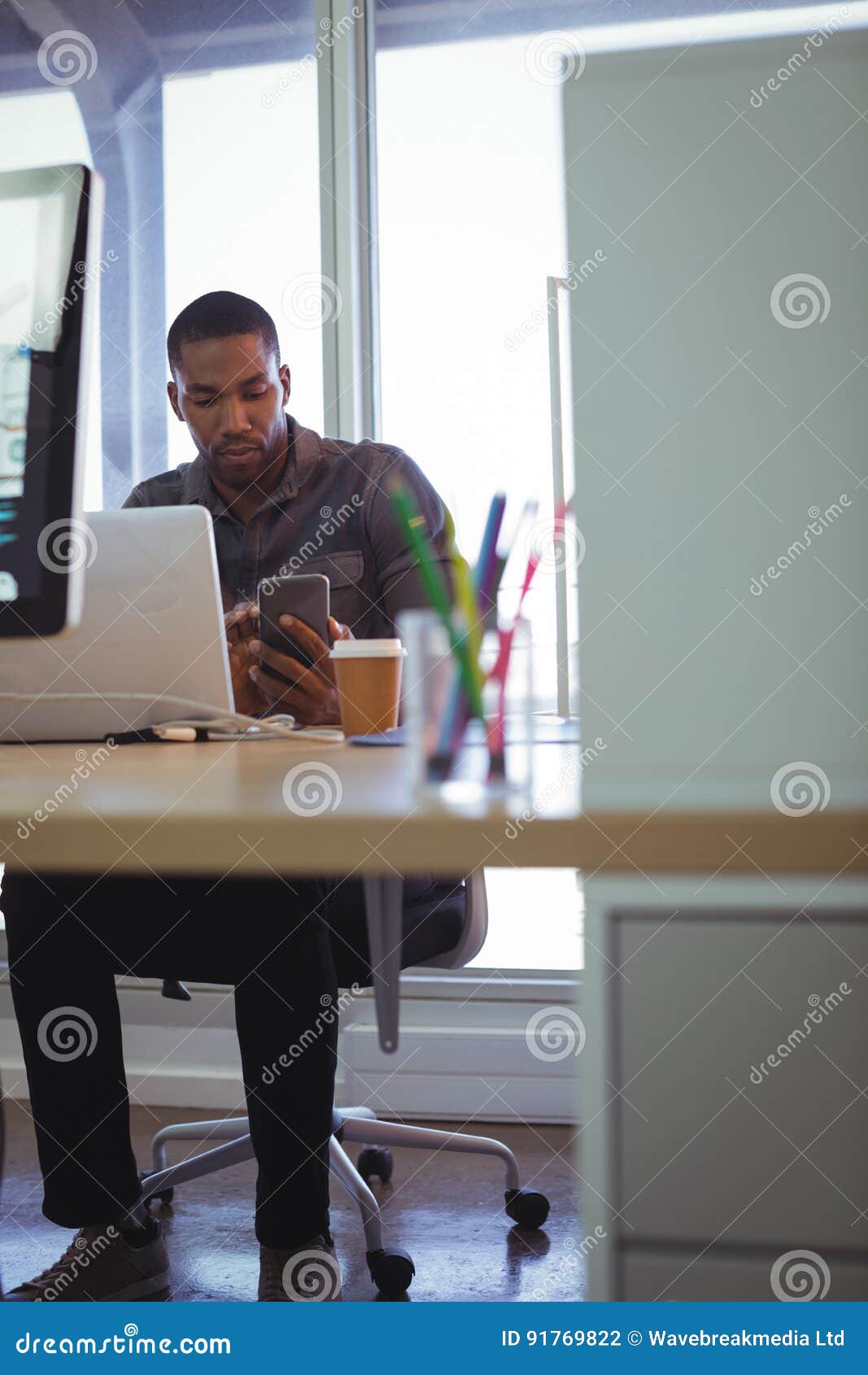 Businessman Texting with Mobile in Creative Office Stock Photo - Image ...