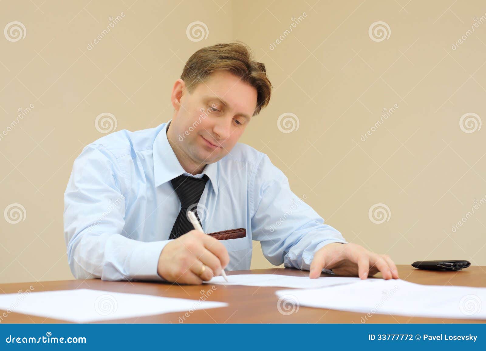 Businessman in Tie Sits at Table and Signs Documents Stock Photo ...