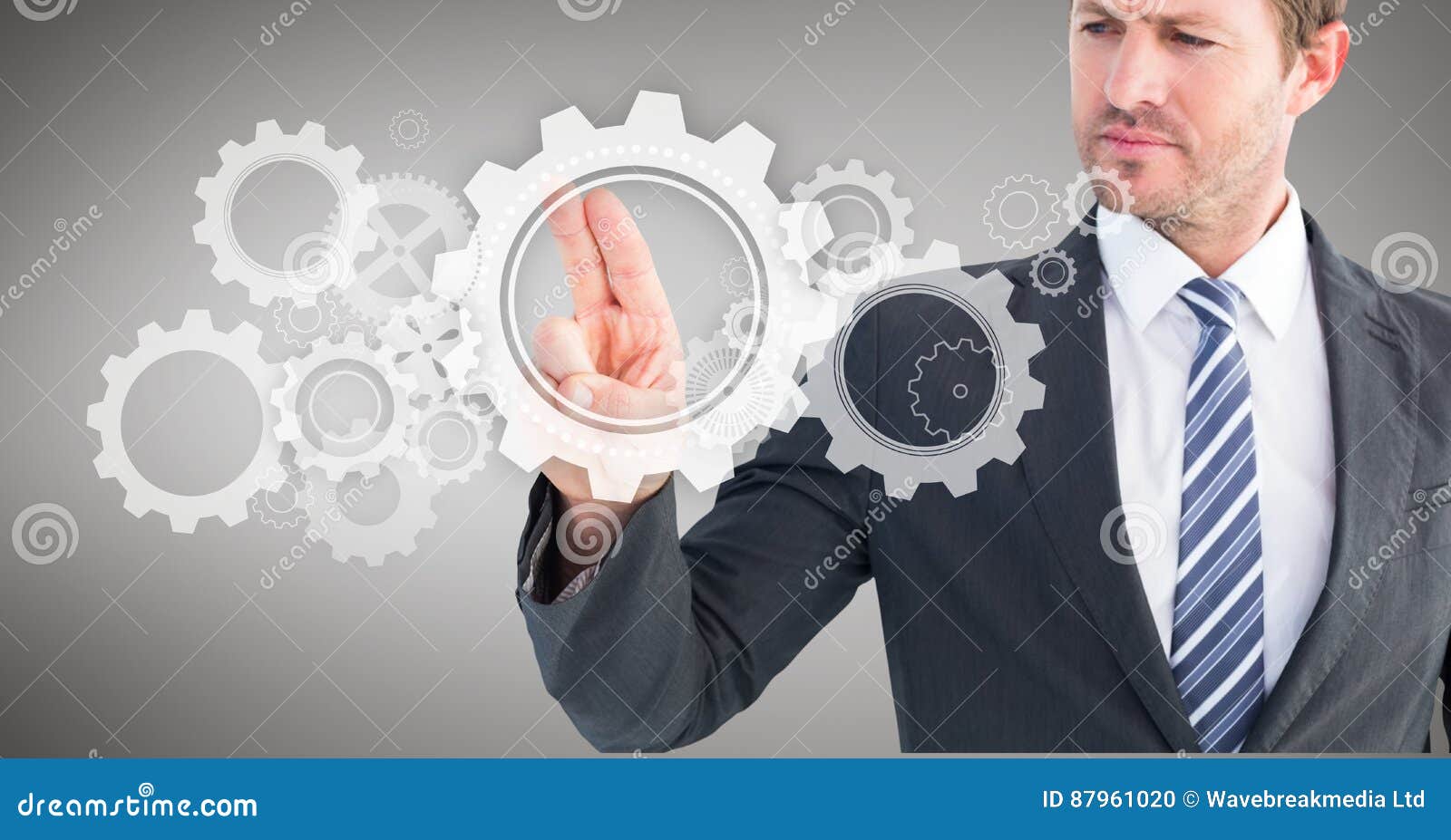 Businessman Touching Cog Wheel on Digital Screen Against Grey ...