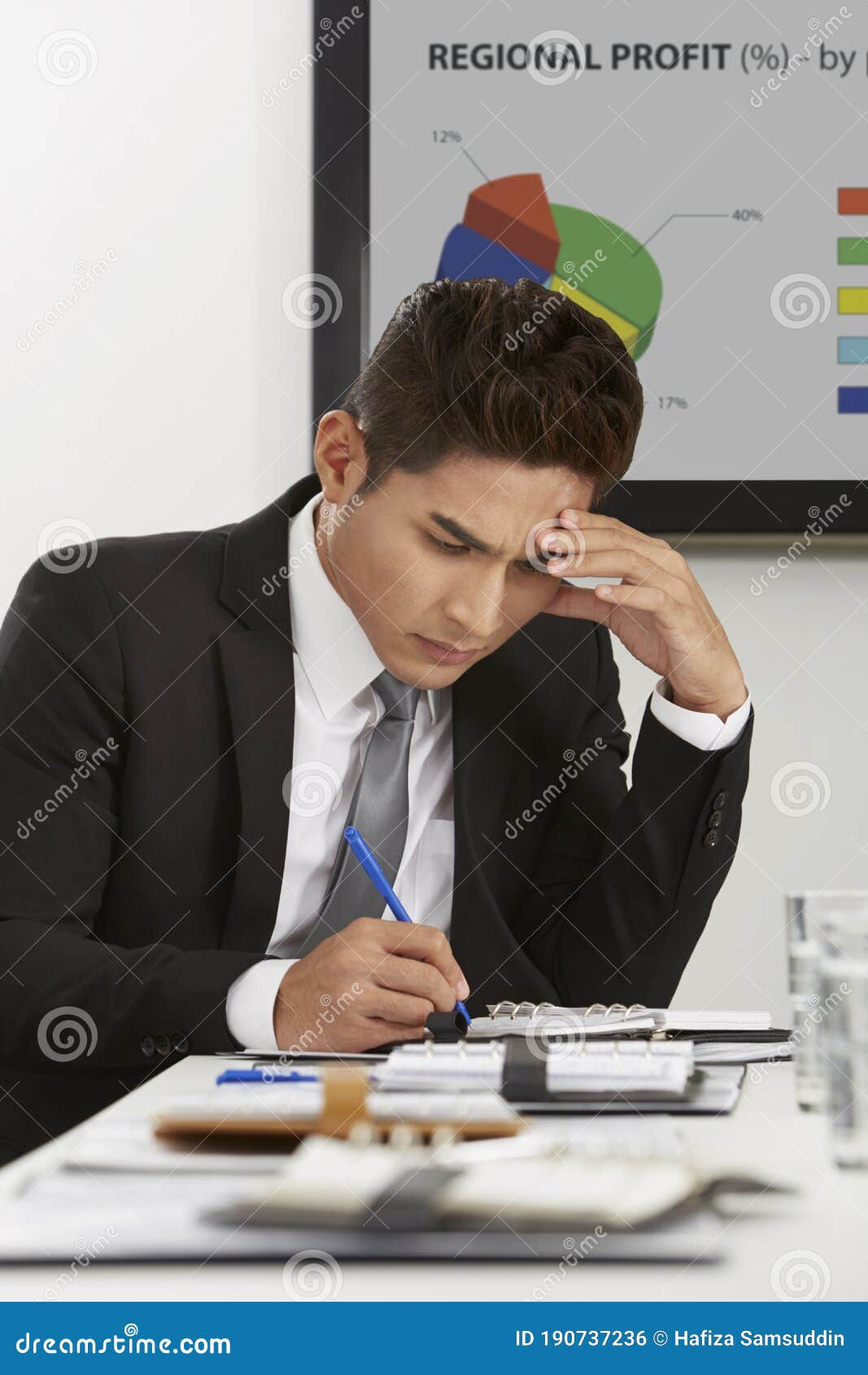 Businessman Touching His Forehead while Writing. Conceptual Image Stock ...
