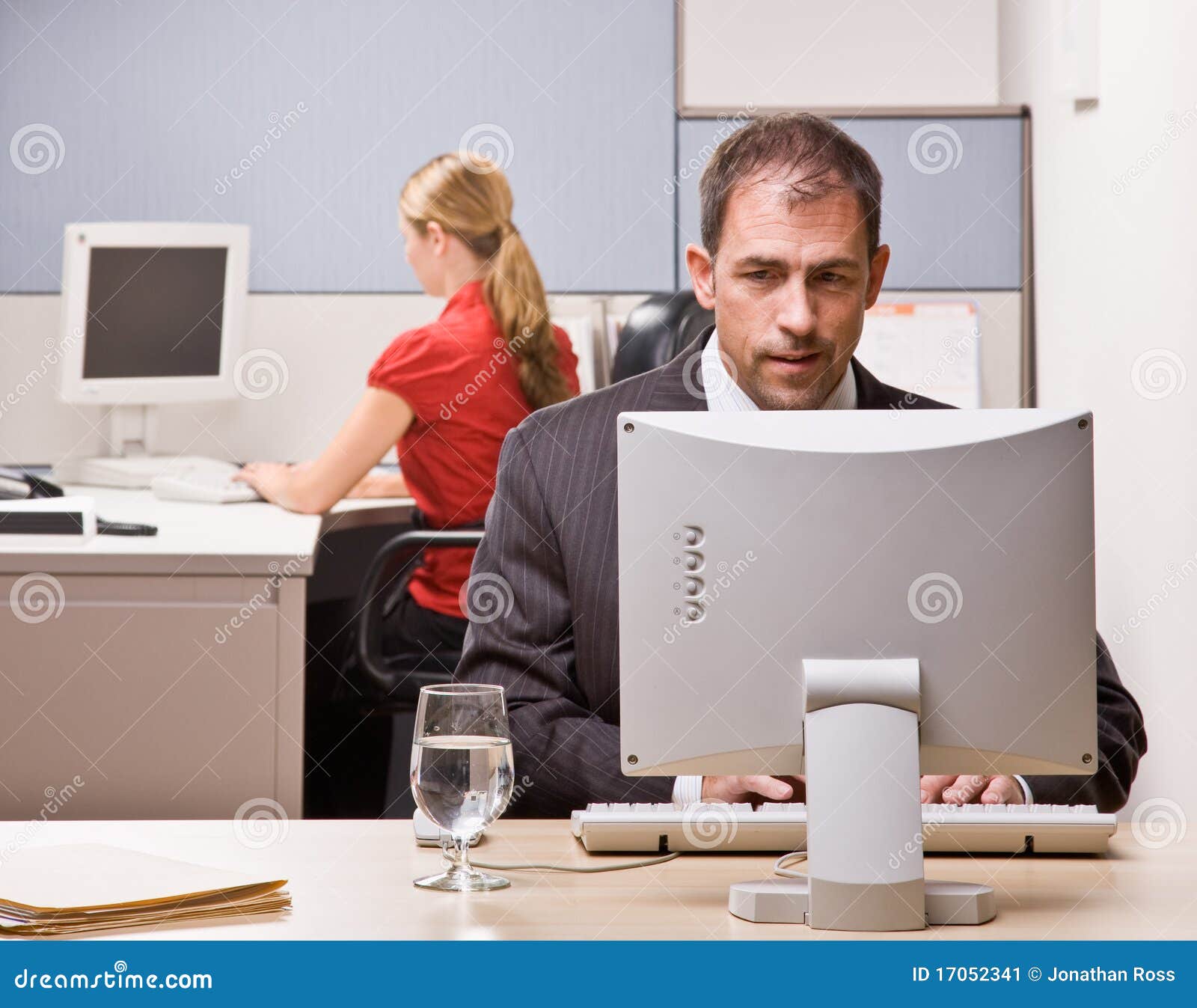 Businessman Typing on Computer at Desk Stock Image - Image of solemn ...