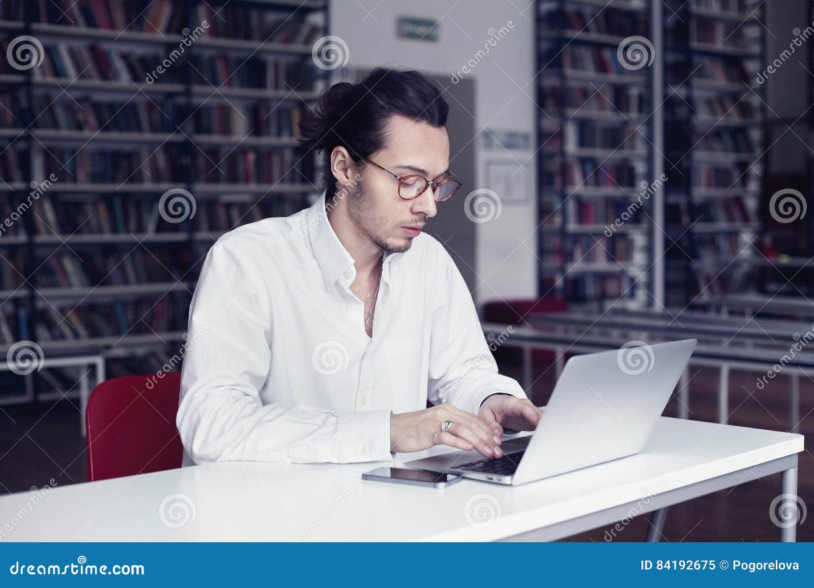 Businessman, University Student Writing and Working at Laptop, in a ...