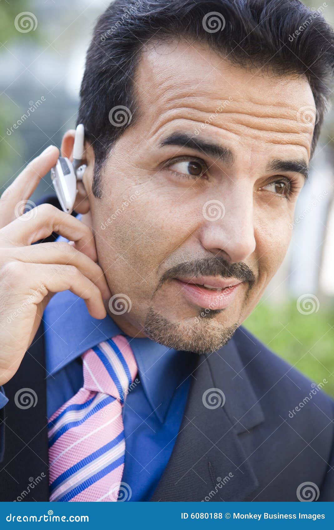 Businessman Using Bluetooth Earpiece Stock Photo - Image of happy ...