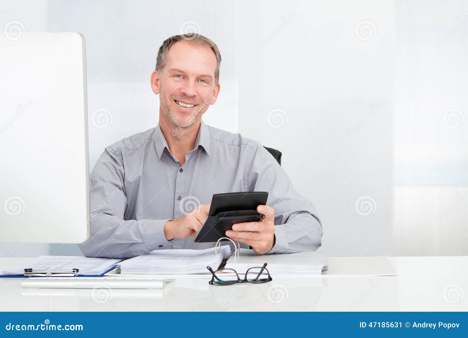 Businessman Using Calculator Stock Image - Image of desk, happy: 47185631 Businessman Using Calculator Stock Image - Image of desk, happy: 47185631